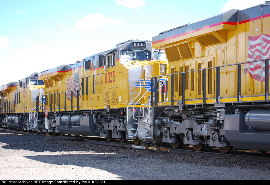 UP 8035 #2 unit behind UP 8036 and UP 8039 #3 unit follow UP 8036 thru UP Rawlins all snow covered.